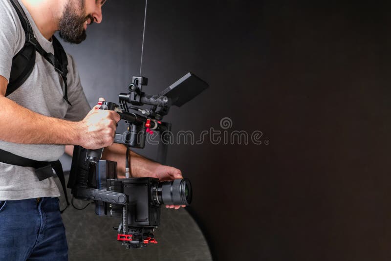 The Cameraman in the Studio Using a Professional Camera with a ...