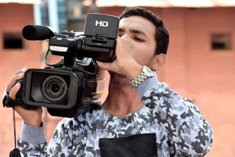Cameraman Using a Professional Camcorder Outdoor Filming Documentary ...