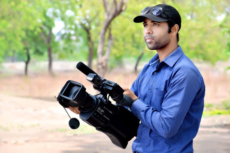 Cameraman Using a Professional Camcorder Outdoor Filming Documentary ...