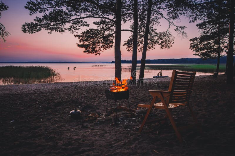 Camp Fire on Sandy Beach, beside Lake at Sunset. Stock Photo - Image of ...