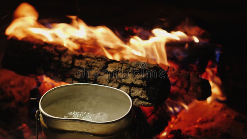 The Camp Kettle is Boiling Around the Fire. Preparation of Hot Tea and ...