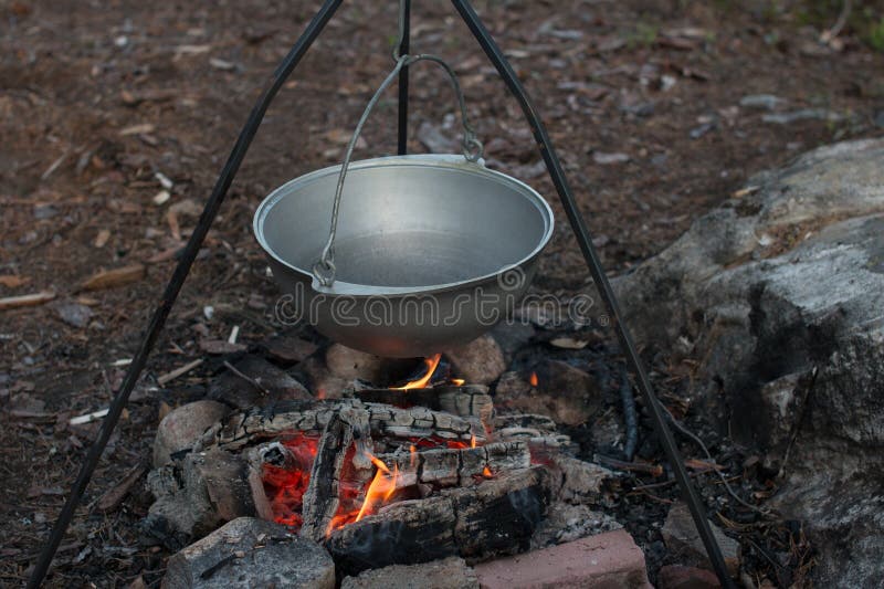 A Camp Pot Hangs Over the Fire on a Tripod. Stock Image - Image of ...