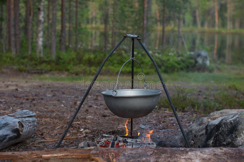 A Camp Pot Hangs Over the Fire on a Tripod. Stock Image - Image of ...