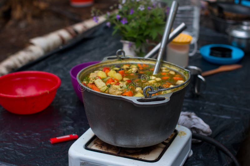A Camp Pot Hangs Over the Fire on a Tripod. Stock Image - Image of ...