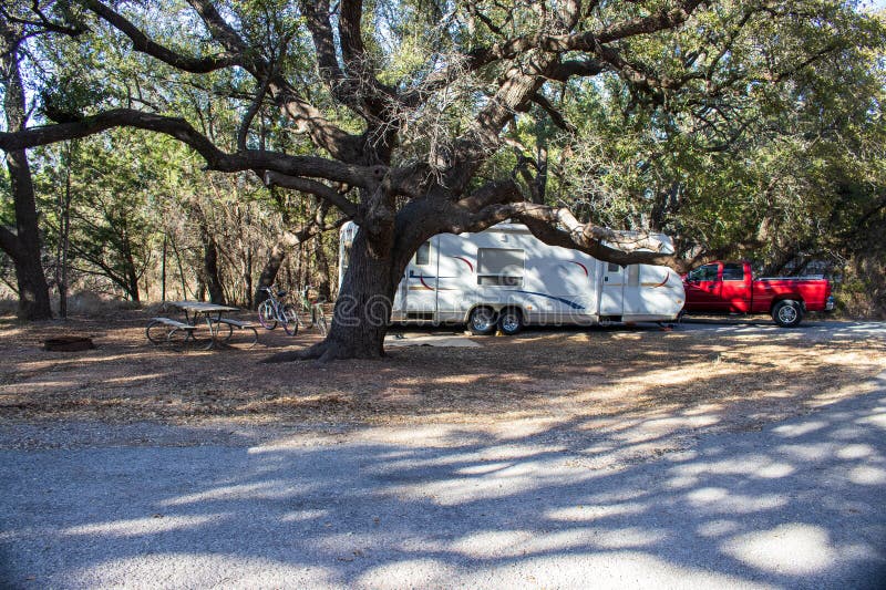 A Camper Trailer and a Truck Parked Under Large Oak Tree - Abilene ...