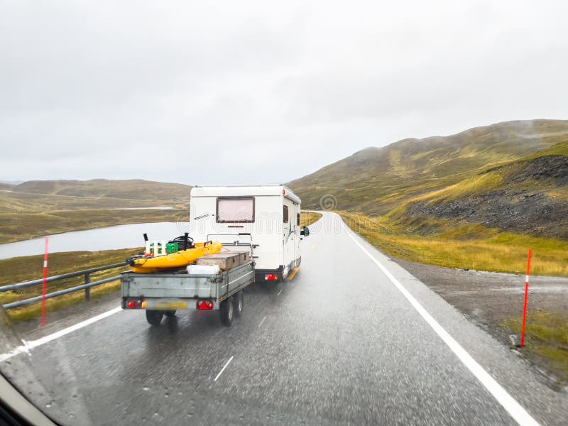 Camper Van Navigating a Wet Road in the Scottish Highlands on a Rainy ...