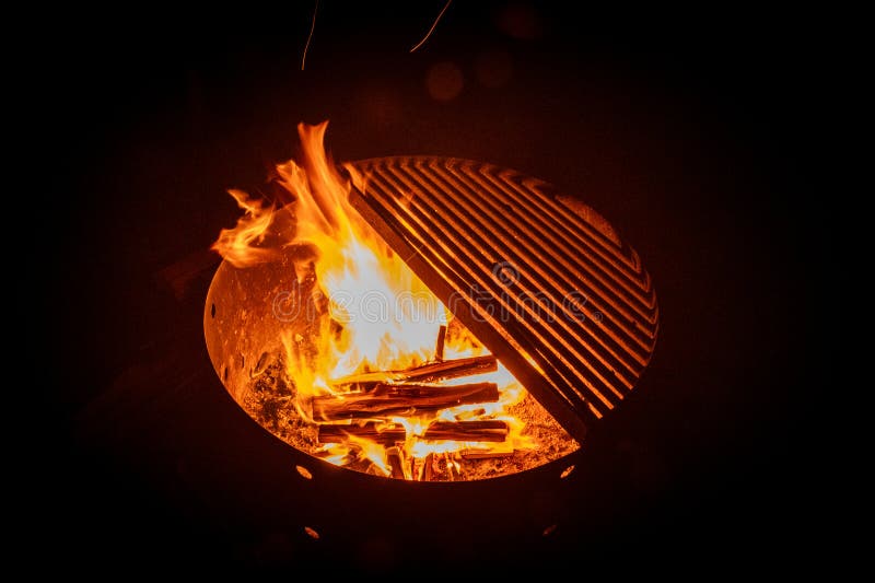 A Campfire Burns Brightly in a Campfire Grate on a Dark Night Stock ...