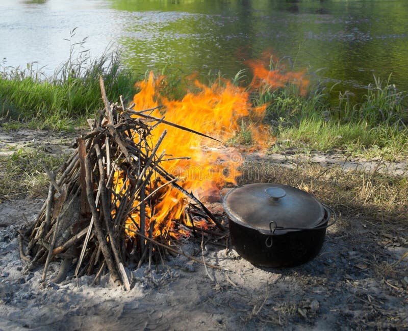 Campfire and Cauldron Near the River Stock Photo - Image of ember ...