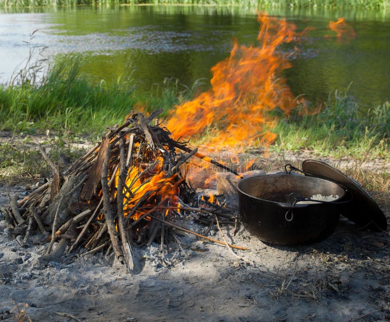 Campfire and Cauldron Near the River Stock Image - Image of coals ...