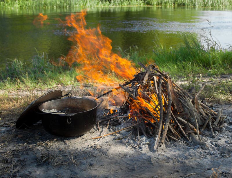 Campfire and Cauldron Near the River Stock Image - Image of coals ...