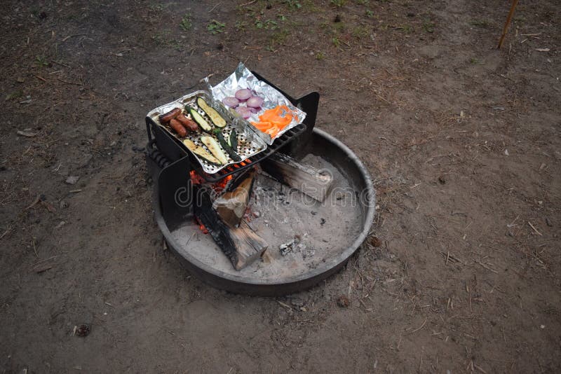 Campground Fire with Food Grilled on Top of it Stock Photo - Image of ...