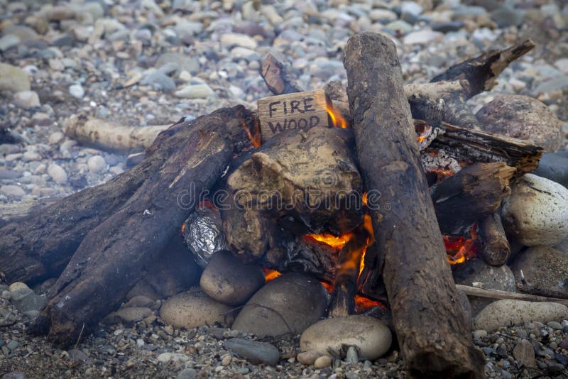 Camping fire on the beach stock photo. Image of logs - 172492844
