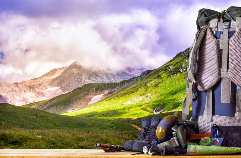 Camping Gear, and Backpack on a Background of Mountains. Stock Image ...