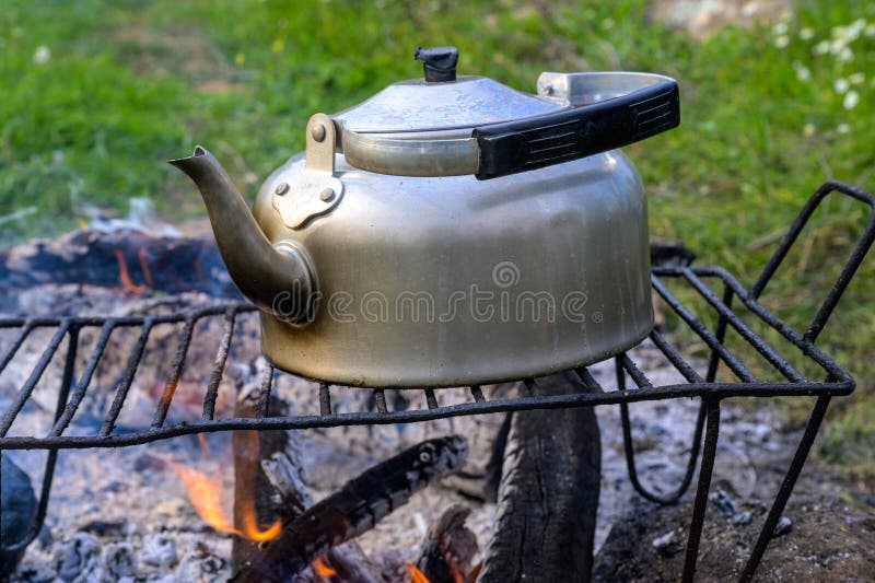 Camping Kettle on a Grill Over an Open Fire in a Forest Setting Stock ...