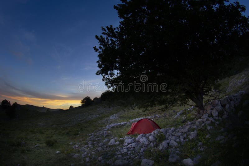Camping with orange tent stock image. Image of sunset - 262693181