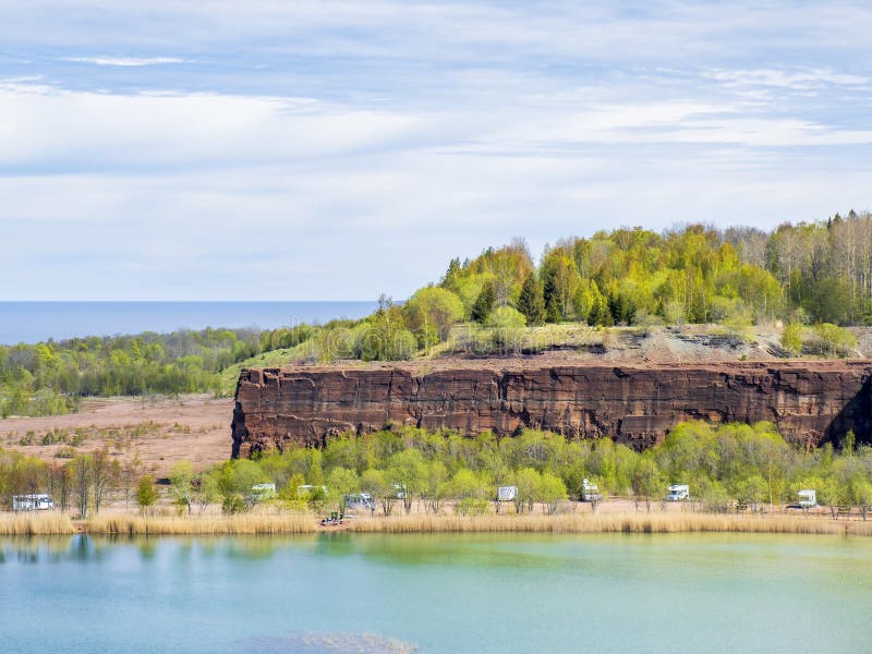 Camping at a Rock Face in an Old Quarry with a Lake Stock Photo - Image ...