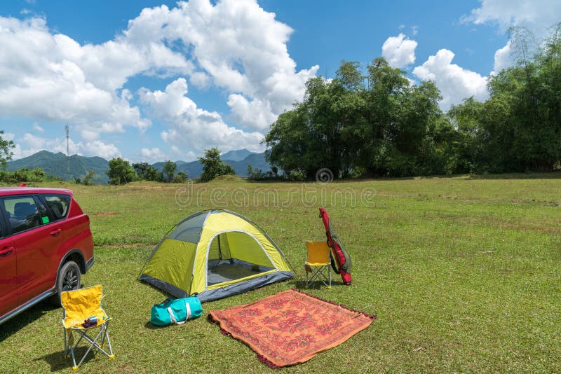 Camping Site on Grass Field with Tent and Car beside Tent. Leisure ...