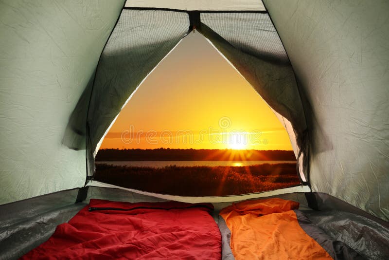 Camping Tent with Sleeping Bags Near River at Sunset Stock Image ...