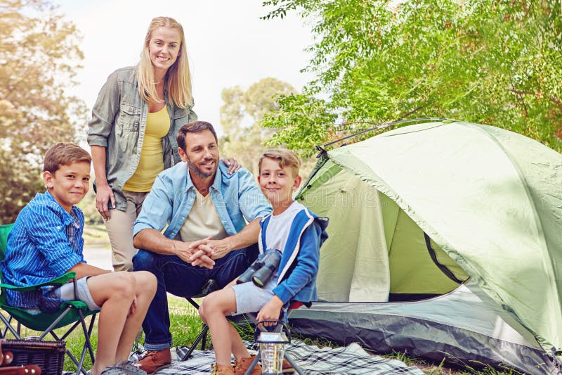 Camping is What we Do. a Family of Four Camping in the Woods. Stock ...