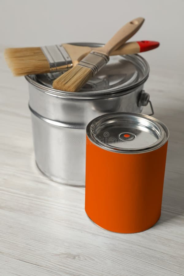Can of Orange Paint, Bucket and Brushes on White Wooden Table Stock ...