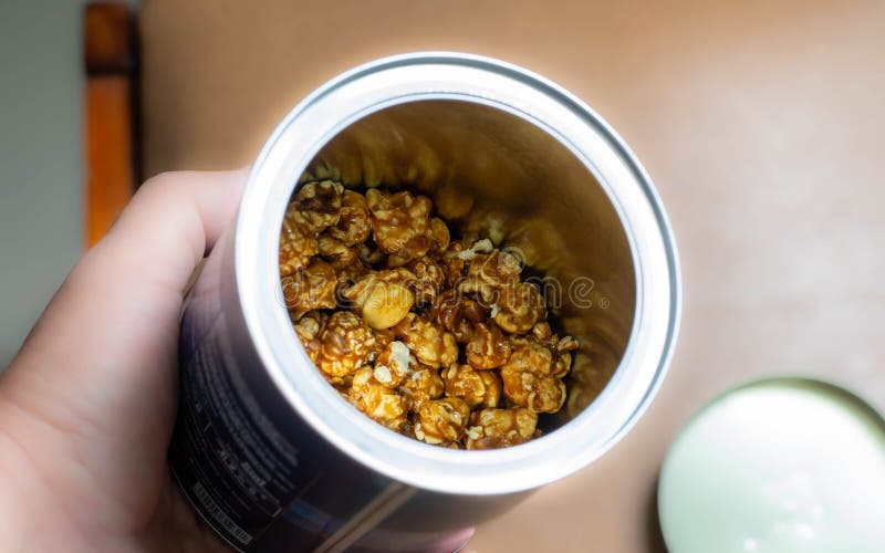 Can of Popcorn in Hand, Chocolate Red Popcorn Stock Image - Image of ...