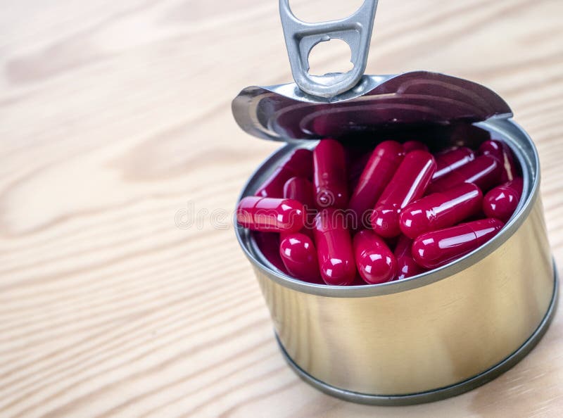 Can with red capsules stock image. Image of business - 131890117