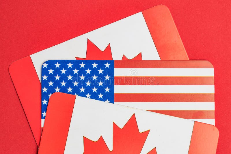 Canadian and American Flags on Red Background: Symbolizing North ...