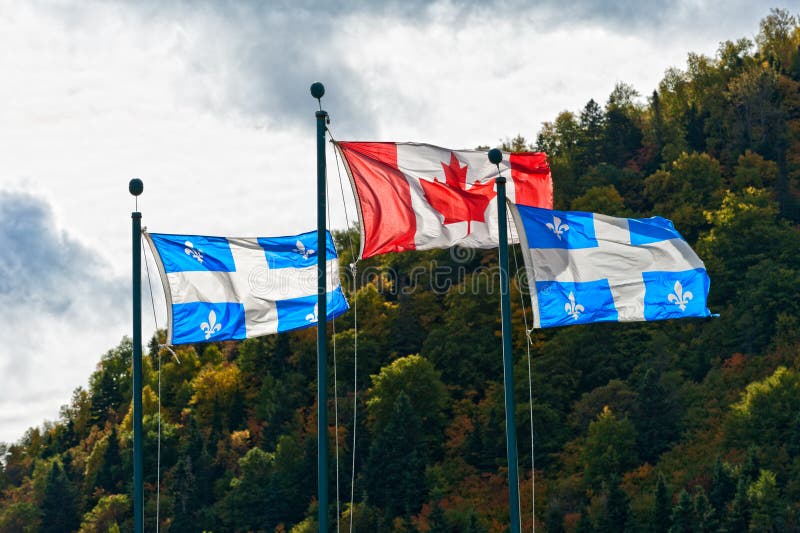 Canadian and the Quebec Flag Stock Photo - Image of flying, quebec ...