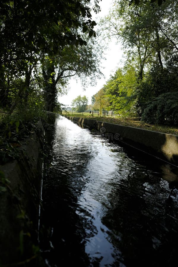 Canal in a Park with Fluent Water Stock Photo - Image of color ...