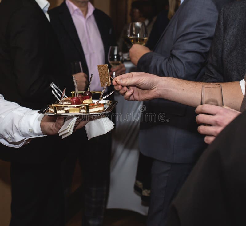 Canape dish held by waiter stock photo. Image of appetizer - 65726638