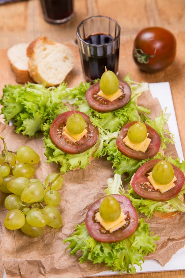 Canape with grape stock image. Image of tomato, paper - 80726079