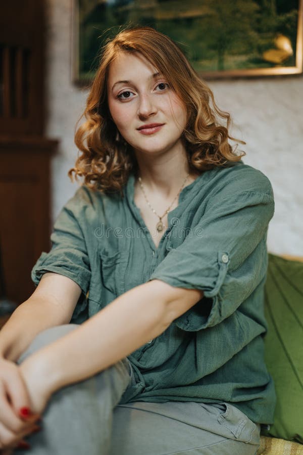 Casual Portrait of a Young Woman Sitting Indoors in a Comfortable ...