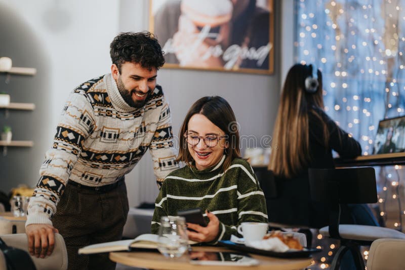A Candid Moment of Two Young People Collaborating in a Casual Cafe ...