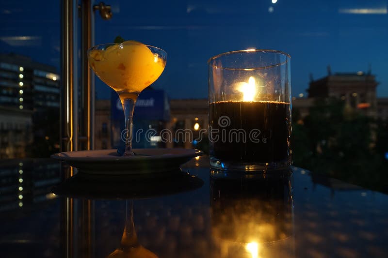 A Candle and a Cocktail are on the Table. Open Veranda. Night. Stock ...