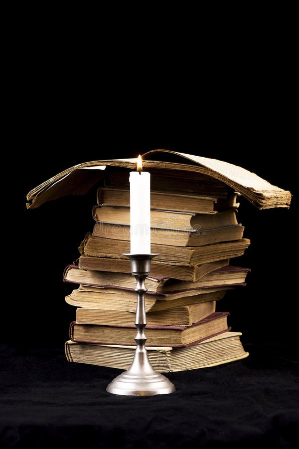 Stack old book and candle. stock photo. Image of life - 20566600