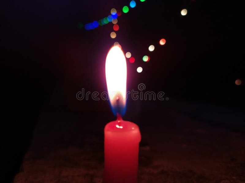 A CANDLE FLAME GIVE LIGHT in DARK NIGHT with LIGHT BILINKING BEHIND ...