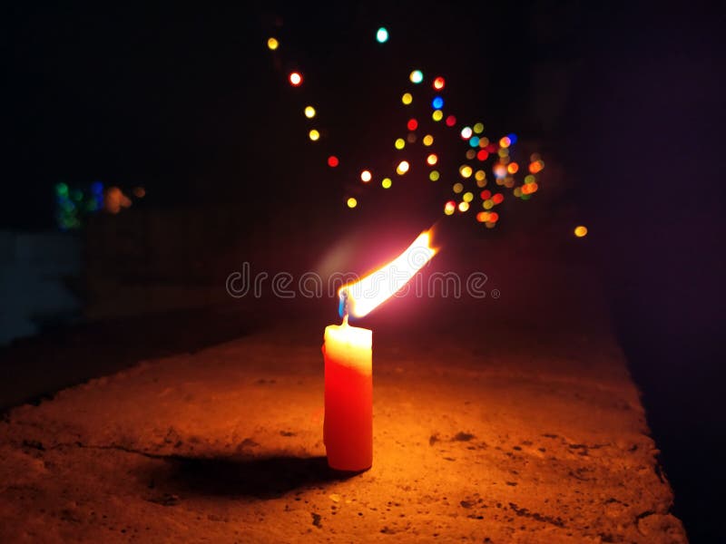 A CANDLE FLAME GIVE LIGHT in DARK NIGHT with LIGHT BILINKING BEHIND ...