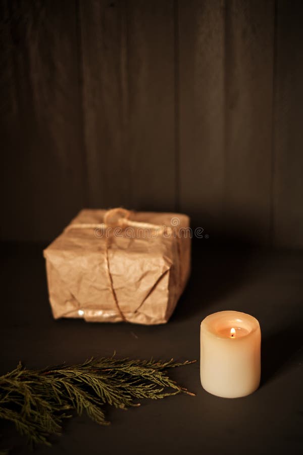 A Candle with Kraft Paper Wrapped Gift Package Stock Image - Image of ...
