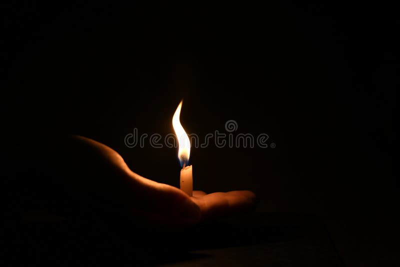 Candle in Hand. Small Candle with a Curved Flame. Complete Darkness ...