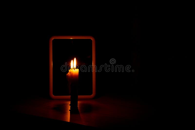 Candle Light in the Reflection of a Mirror Standing on a Table in a ...