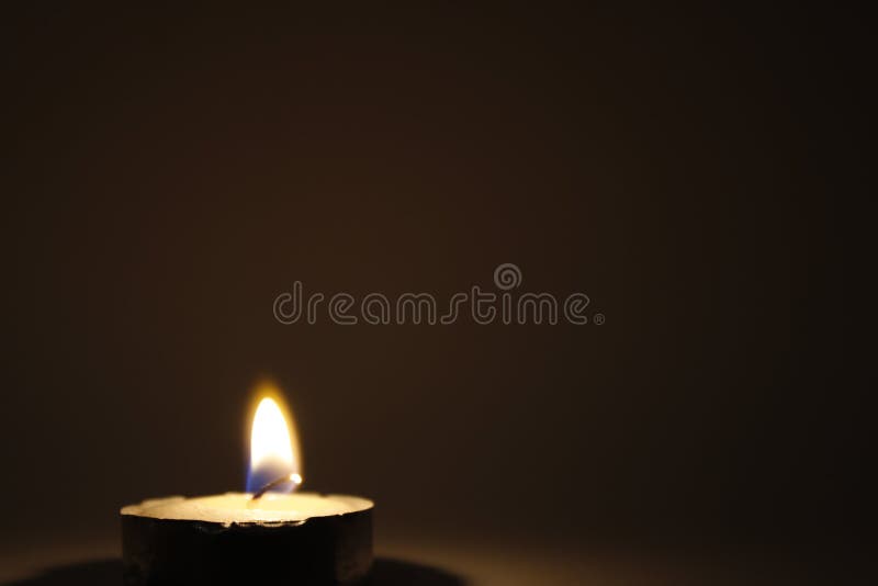 Candle lit in dim light stock photo. Image of black - 182761258