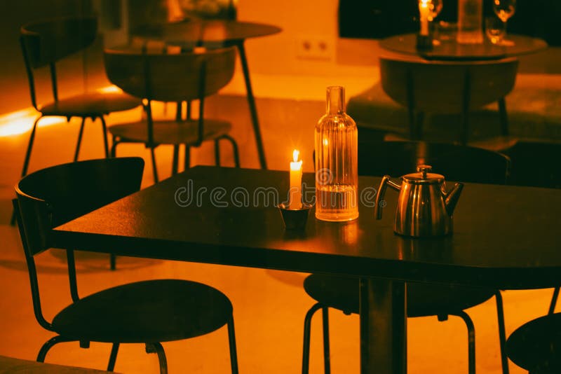 Candlelight Dinner in Restaurant. Candles in Candlesticks Burn on Black ...