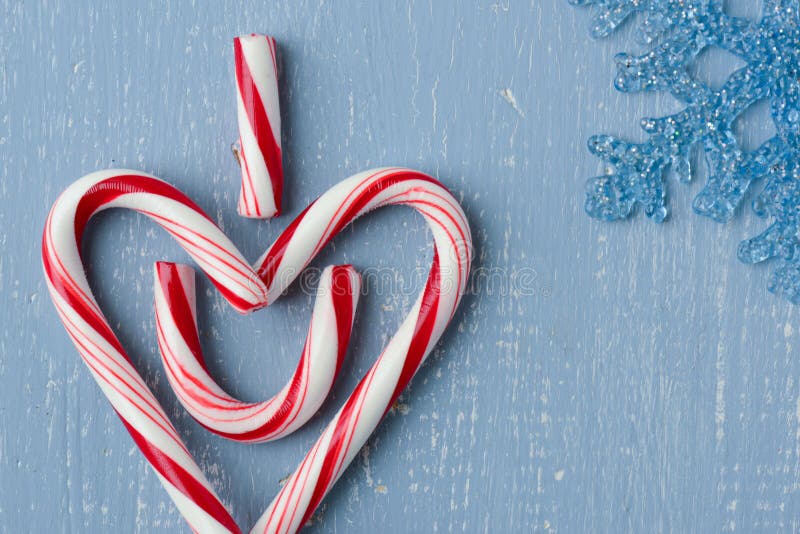Candy Cane Heart Symbol on Blue Wood with Snowflake Upper Right Side ...