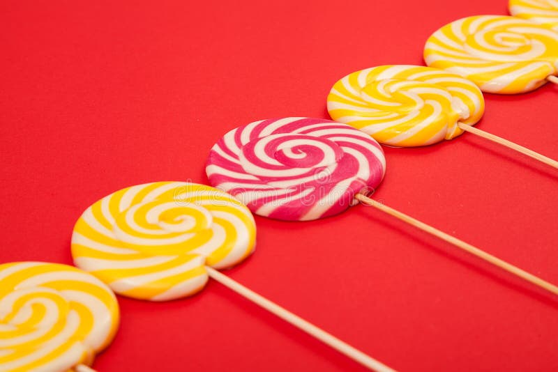 Candy Sticks are Displayed in Diagonal on a Red Background. Stock Image ...