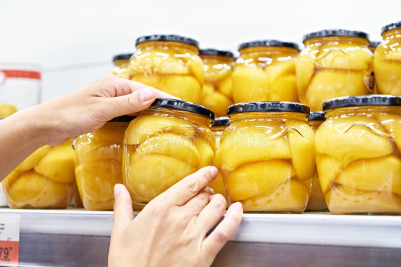 Canned Peaches in Glass Jar in the Hands in Store Stock Image - Image ...