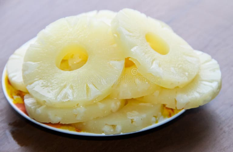 Canned Pineapple on a Plate on Wooden Table Stock Image - Image of ...