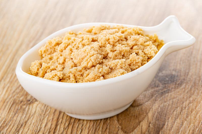 Canned Cod Caviar in Bowl in Fish Shape on Wooden Table Stock Photo ...