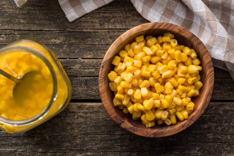 Canned Sweet Corn in Bowl on Wooden Table. Top View Stock Photo - Image ...