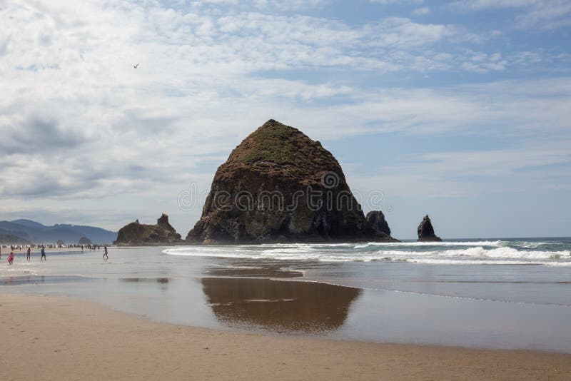 Cannon Beach, Oregon Coast: the Famous Haystack Rock Reflects Itself in ...