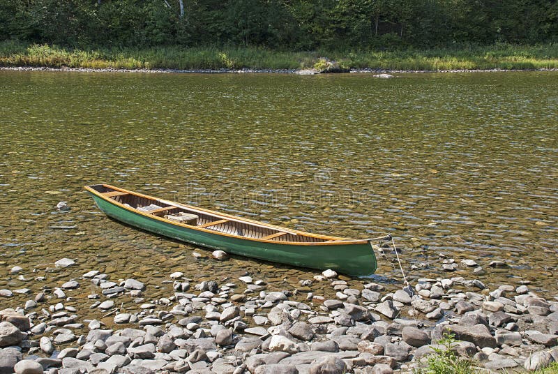 Canoe Anchored by River Bank Stock Image - Image of outdoors, landscape ...